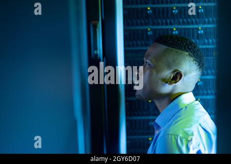 African american male computer technician using laptop working in ...