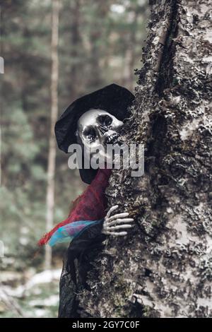A human skeleton, a ghost in rags and a hat, greedily grabbed a pumpkin ...