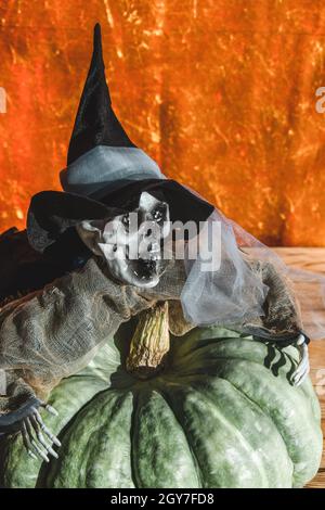 Human skeleton, ghost in rags and hat, peeks out from behind an old ...