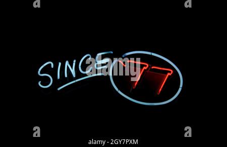 Vintage Neon 77 Sign on Restaurant Window Stock Photo - Alamy