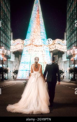 Couple has fun winter walk against background of ice of frozen lake ...