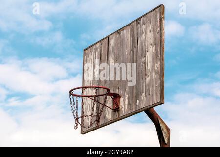 Old wooden ghetto style basketball hoop. Basketball ring with chains ...