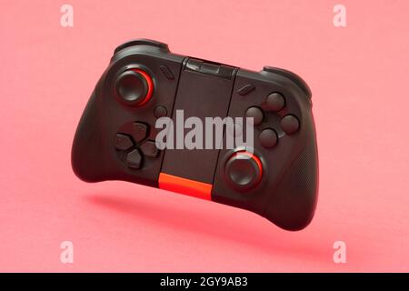Video game controller falling on the yellow background Stock Photo - Alamy