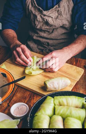 Man Cooking Cabbage Rolls Stuffed with Ground Meat Stock Photo - Alamy