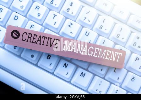 Hand writing sign Creative Management. Word Written on Managing of ...