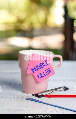 Hand writing sign Invisible Killer. Internet Concept presence into the ...