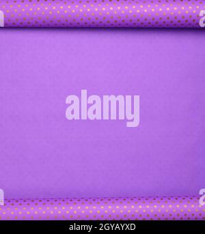 Purple paper bundle in a golden dot deployed, wrapping paper, copy ...