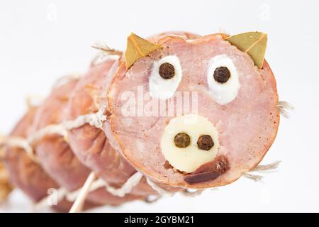 salami with a pig's face made from cheddar cheese, pepper and bay ...