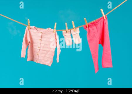Clothesline with pinned baby clothes close up Stock Photo - Alamy