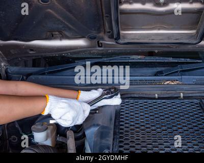 Mechanic holding a block wrench handle while fixing a car Stock Photo ...