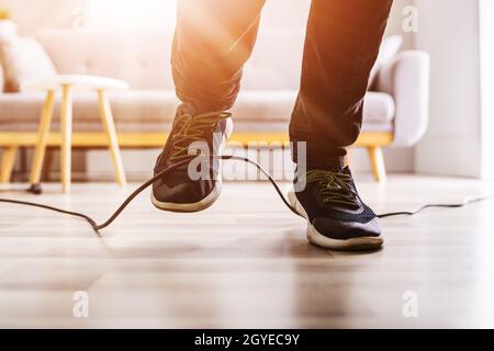 Wire Cord Trip Over And Fall. Feet Stumble On Cable Stock Photo - Alamy