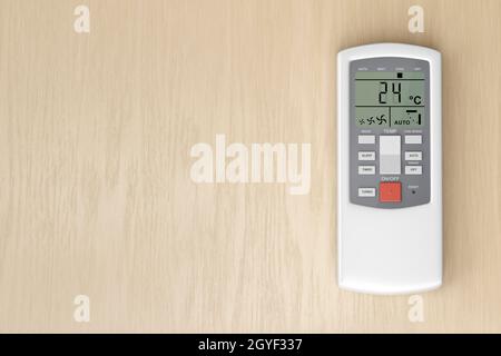 Remote control for air conditioner on wooden table Stock Photo - Alamy