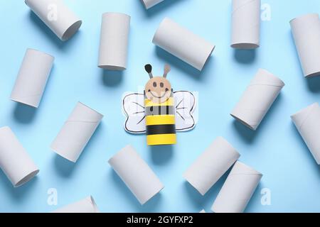 Bee made of cardboard and tubes for toilet paper on purple background ...