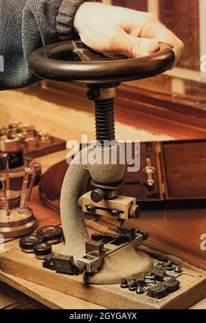Vintage clock resting on wooden surface with military gas mask and ...