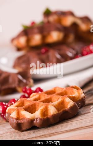 Waffles with chocolate icing and red currant Stock Photo - Alamy