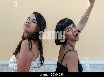 Photo of two joyful beautiful women smiling and holding map while ...