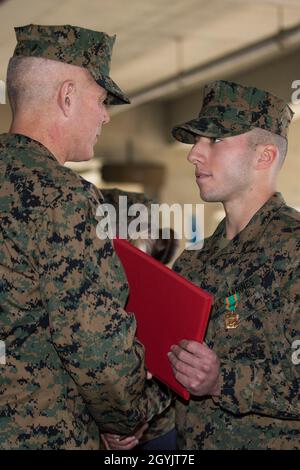 A marksman observer with the Provost Marshal’s Office, relays ...