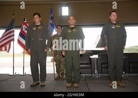 Col. Michael Blake, 154th Operations Group commander, presents the ...