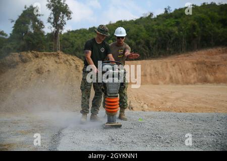 Seabees and Marines work together to build a helicopter landing at the ...