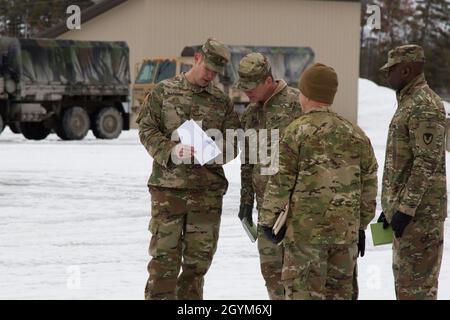 A 548th Combat Sustainment Support Battalion Soldier (middle) embraces ...