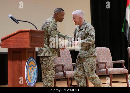 Navy Adm. Alvin Holsey, center, is flanked by Gen. Dan Caine, left ...