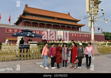 BEIJING, CHINA - OCTOBER 2, 2021 - Tourists hold up the five-star red ...
