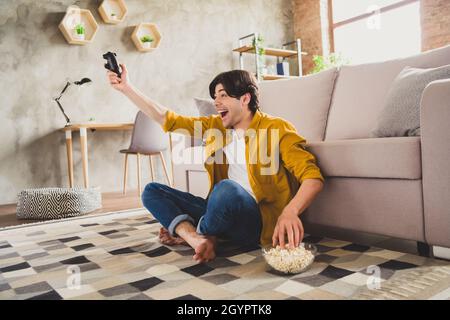 Photo of astonished man sit floor two arm direct look empty space ...