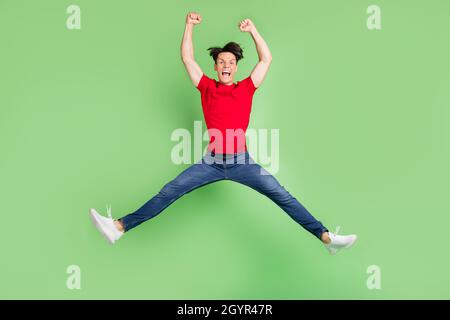 Full length photo of crazy lucky person raise fists triumph jumping ...