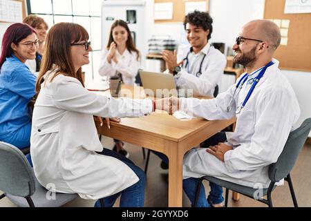 Group of doctor clapping to partners handshake in a medical meeting at ...