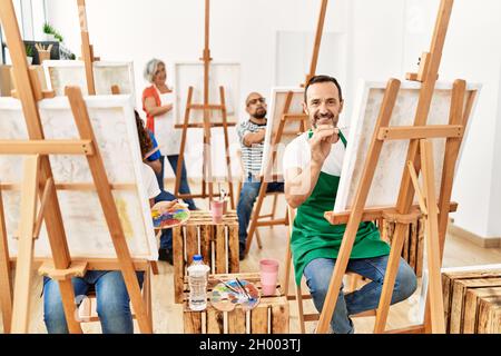 Group of middle age draw students sitting on the table drawing at art ...