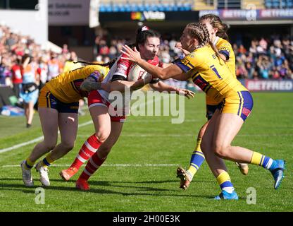 St Helens' Leah Burke (centre) and Erin Stott (right) celebrate after ...