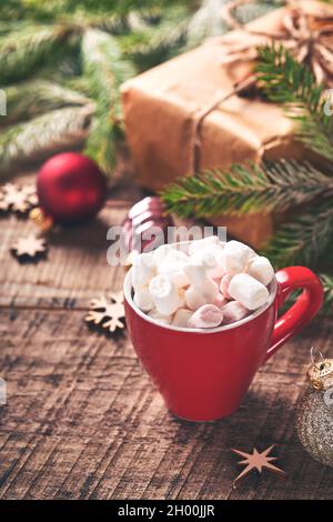 Cup with marshmallow and xmas gift boxes. Christmas holiday with ...