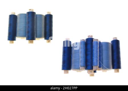 Set of thread spools on blue background Stock Photo - Alamy
