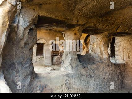 Interior of cave halls carved into mountain with pillars supporting ...