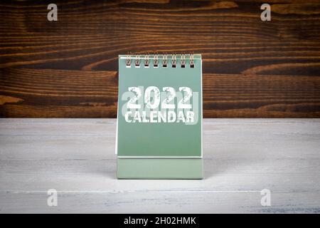 Calendar or planner on dark wood background with copy space. Business ...