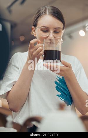 Beautiful young woman with cup of tasty coffee at home Stock Photo - Alamy