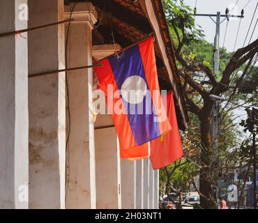 The Lao National Flag with the red flag with communist symbols of a ...