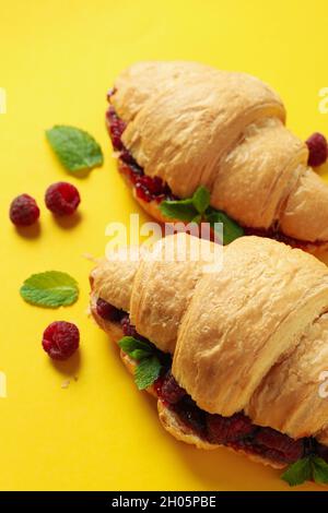 Croissants with raspberry jam on yellow background Stock Photo - Alamy