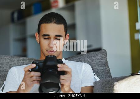 Black male photographer chimping his shot in the viewfinder Stock Photo ...
