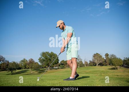 busy golfer in cap with golf club, golf course Stock Photo - Alamy