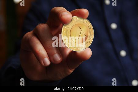 Avalanche Avax cryptocurrency golden coin in hand abstract concept ...