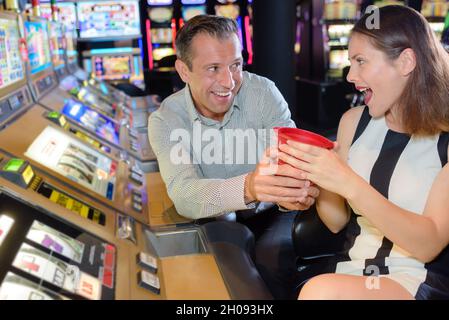 group of friends playing slot machines Stock Photo - Alamy