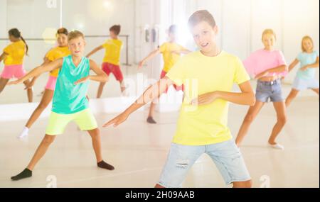 Group children learn dance movements in class Stock Photo - Alamy