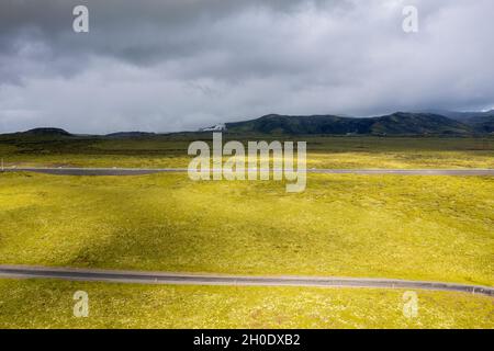Roads on a landscape covered with moss in dramatic light and stormy ...