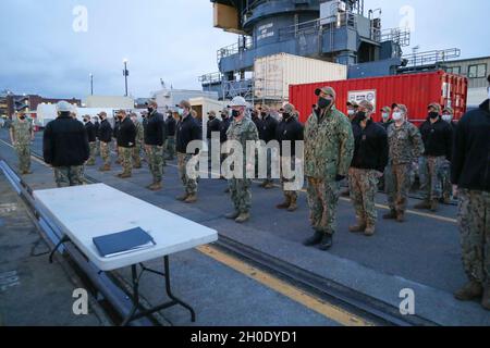 Crew members stand in formation at the start of the decommissioning ...