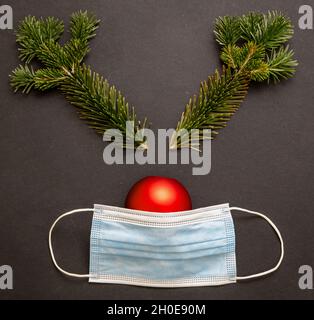 Winter holidays and covid-19 concept. Happy man in face mask and santa ...