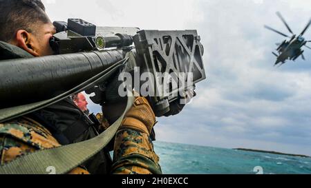 A Marine aims a FIM-92 Stinger portable anti-aircraft missile launcher ...