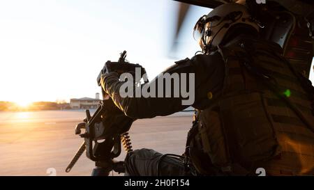 Naval Aircrewman mans a .50-caliber machine gun during an initial ...