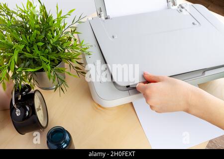 Hands of a woman using a copying machine close up Stock Photo - Alamy