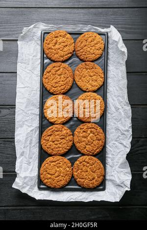 Board with tasty hojicha cookies on black wooden background Stock Photo ...
